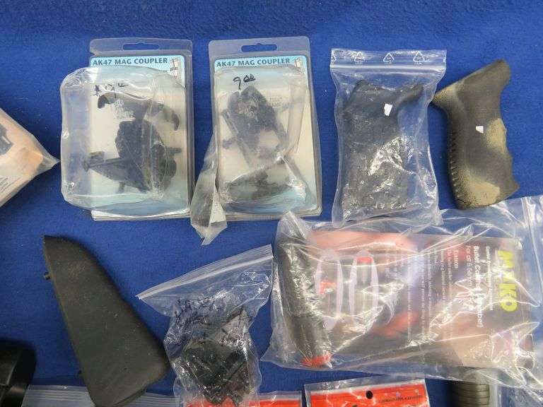 Misc. gun parts including AK47 mag couplers, M16 mag holders, grips and ...
