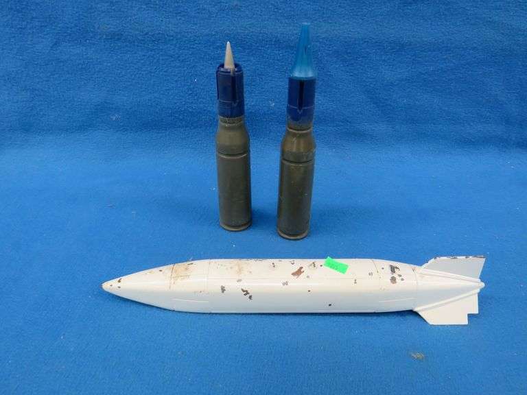 Two inert 25mm rounds and ??? - AAA Auction and Realty