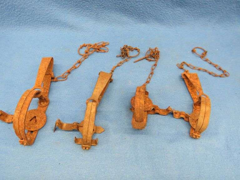 Four vintage leg hold traps - AAA Auction and Realty
