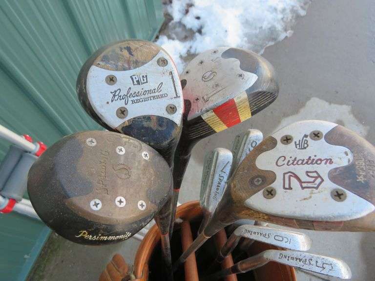 Voit golf bag with 4 woods and seven irons along with a pair of ...