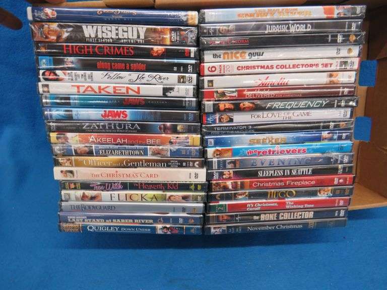 37 new in the package DVDs. Titles as pictured. - AAA Auction and Realty
