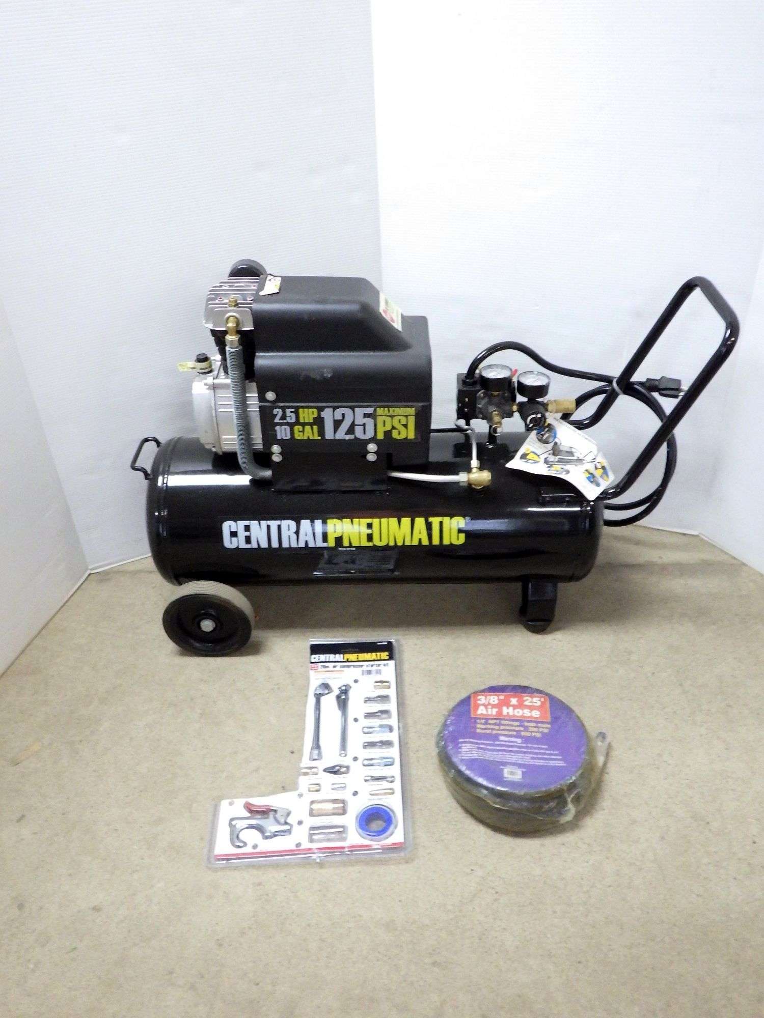 Central Pneumatic 2.5HP 10 Gallon 125 PSI rolling portable air compressor with 3 8 x 25 air hose and accessories new Albrecht Auction Service