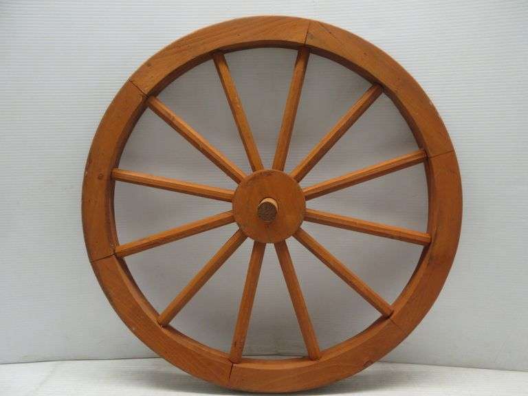 Wooden spoke wheel with decorative metal rim around outside, 24"Dia ...