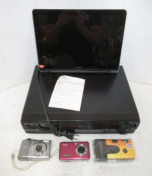 VHS VCR, (2) digital cameras, NIP disposable camera, and a Macbook pro ...