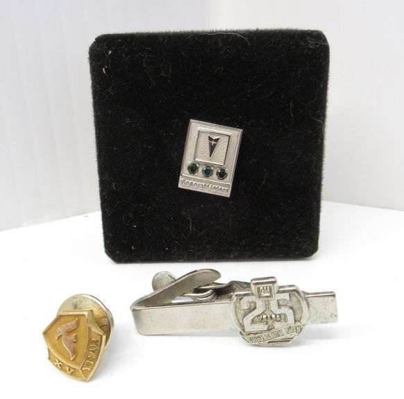 GM tie tack and pin, and a Firestone pin, good, Except where ...