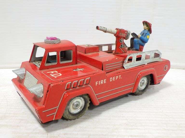 Tin friction toy fire truck lithograph with spinning fireman, Japan, 3 ...