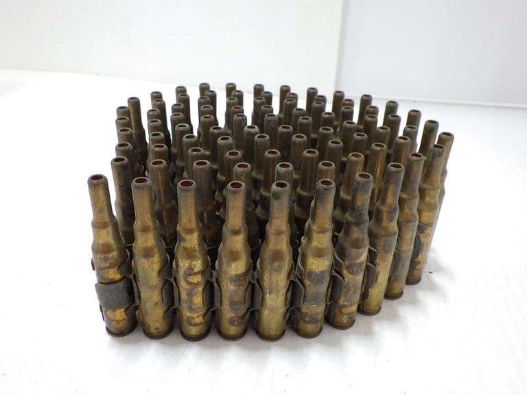 Linked belt of approx. (50) 5.56 dummy rounds, head stamps are LC 66 ...