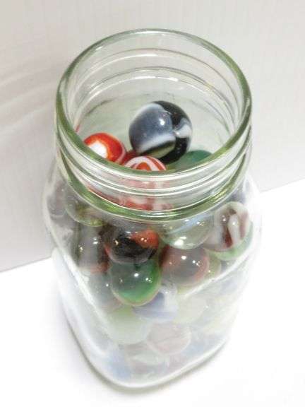 (2) Jars of old marbles, one container has over (100) marbles, other ...