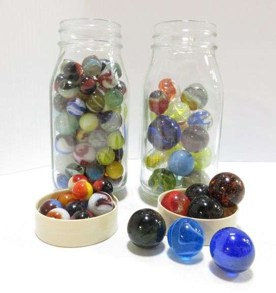 (2) Jars of old marbles, one container has over (100) marbles, other ...
