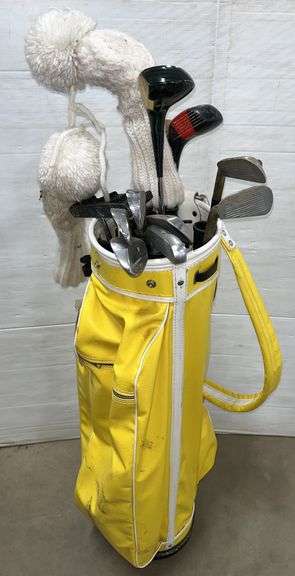 Yellow golf bag with clubs - Albrecht Auction Service