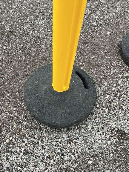 Portable barrier post with retractable belt, bottom is weighted ...