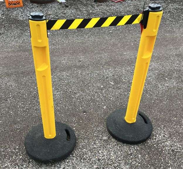 Portable barrier post with retractable belt, bottom is weighted ...