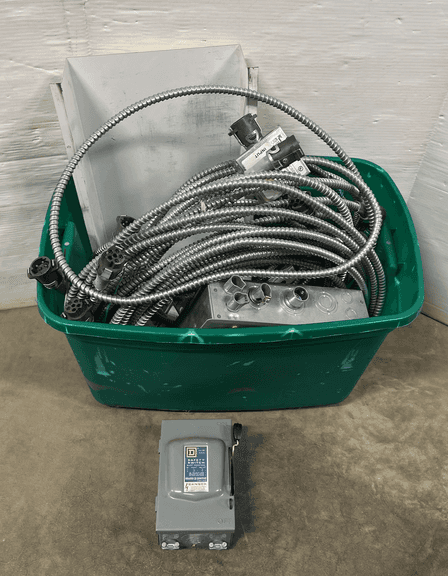 Tote of electrical whips with breaker panel, breakers, and disconnect ...