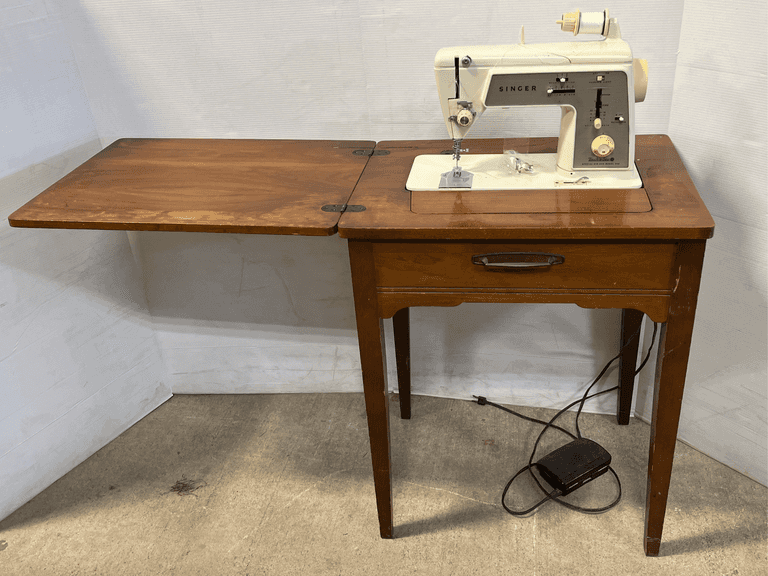 Singer sewing machine in brown wooden sewing table, has original pedal ...