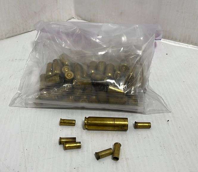 Spent brass casings, includes: 9mm, 30-30, and 22, dirty mixed lot ...