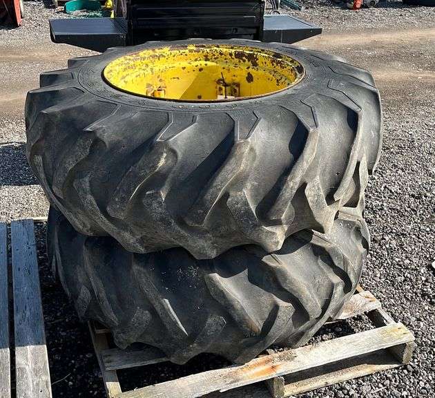 John Deere 14.9x24 rims and tires, the tires are weather checked, the ...