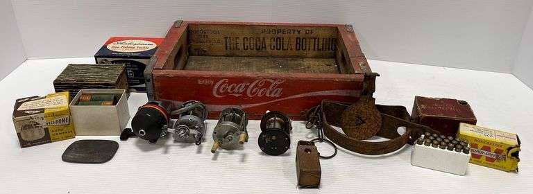 Coca Cola box with collectible fishing reels, shotgun shells, and more ...
