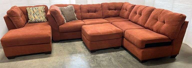 Three-piece Ashley Furniture orange sectional with chaise and ottoman ...