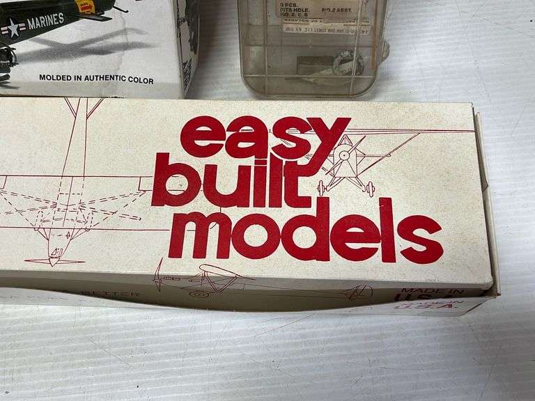 Assorted model airplanes, balsa wood and plastic, with extra parts ...