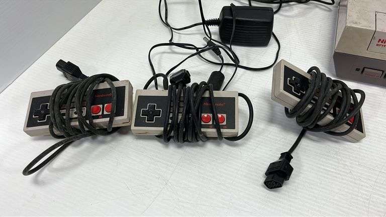 Nintendo Entertainment System, includes: (2) Game consoles, and (5 ...