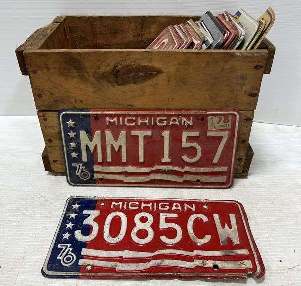 Old wood box with (24) License plates, include: Nine- 1976 license ...