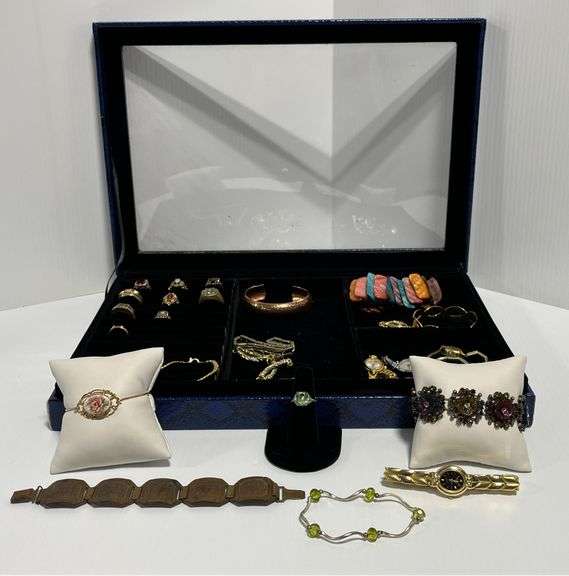 Display case with assorted costume jewelry, bracelets, watches, and ...