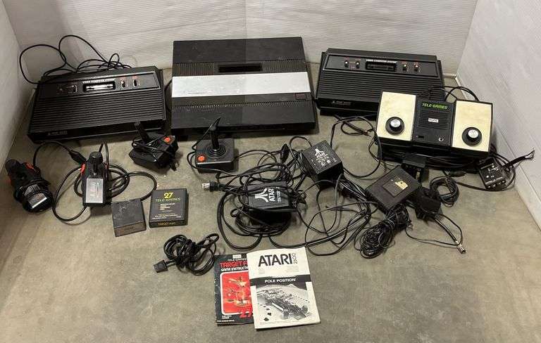 (3) Older Ataris, include: Two- 2600, One- 5200, come with games ...