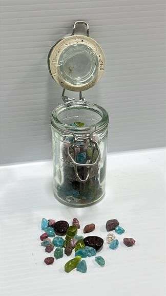 Jar filled with gems, 555 carat total, includes: rubies, garnets, blue ...