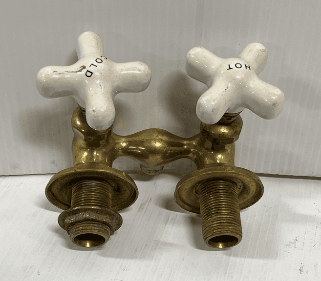 Older brass faucet with porcelain knobs marked hot and cold, used ...