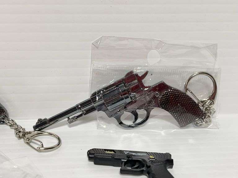 (4) Gun keychains, comes with (3) revolvers and (1) different gun, up ...