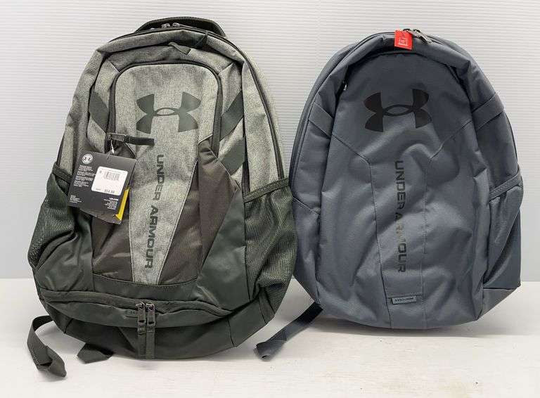 (2) Gray Under Armour backpacks, up to 21"H, new - Albrecht Auction Service