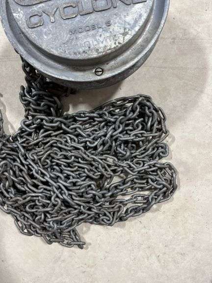 Cyclone chain hoist with long chain attached, has hooks and is well ...