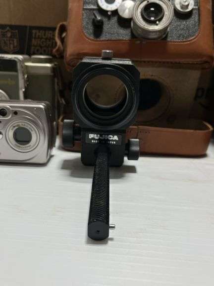 Box of older camera equipment, film cameras, digital cameras, lens ...