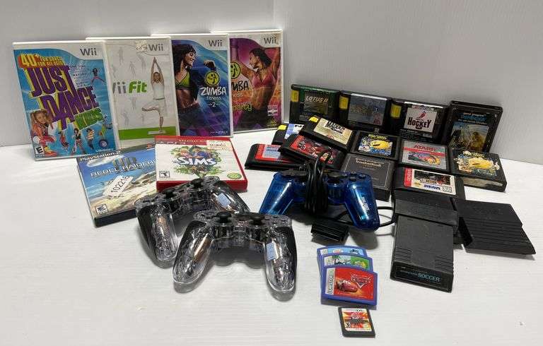 Video game assortment, includes: Wii games, Playstation controllers ...
