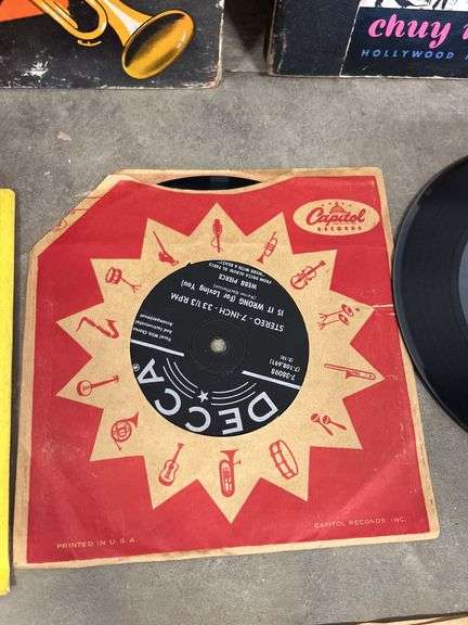 Vinyl record collection of 45s, in original paper sleeves and stand ...