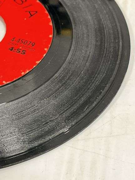 (12) 1970s 45 RPM records in a checkered record case, pop and rock ...