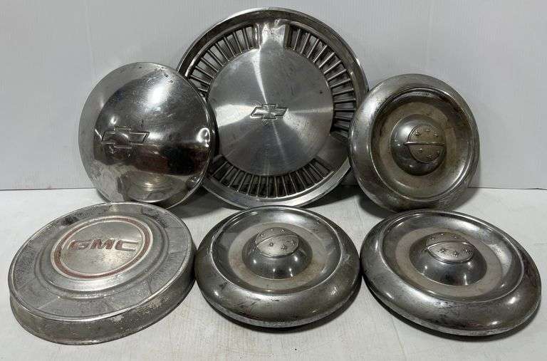 Assorted hub cap and center caps, include: GMC center cap, Chevy center ...