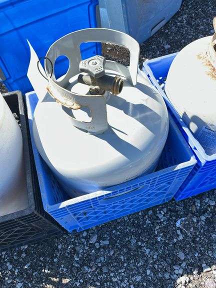 (2) Propane tanks in sturdy milk crates, one about 1/2 full, one about ...