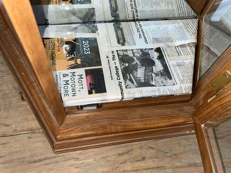 Woodgrain curio cabinet with two glass shelves in bottom, 22"W x 11 1/2 ...