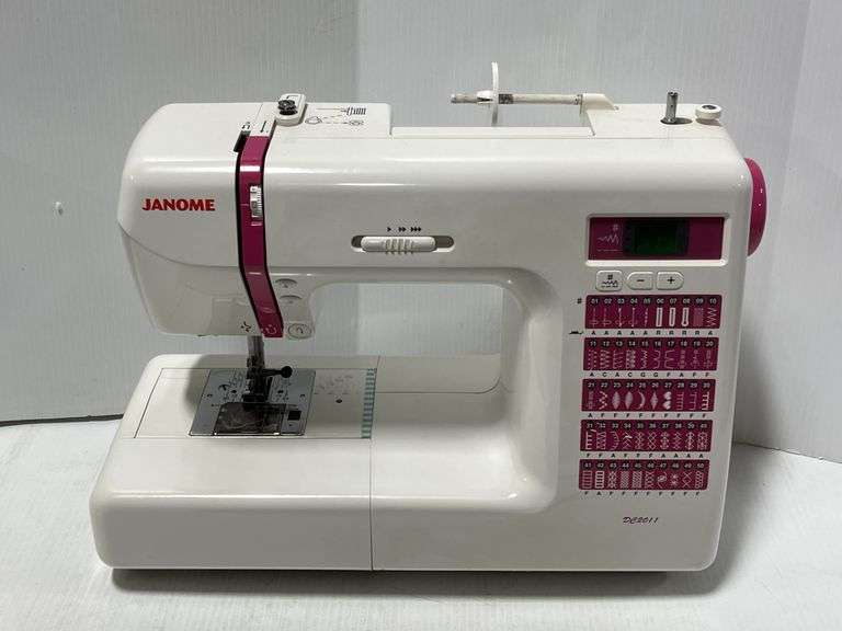 Janome DC2011 sewing machine, comes with six different feet, some bobbins, front drawer is taped ...