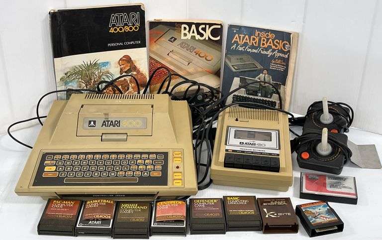 Atari 400 computer with tape player, games, and manuals, with (8 ...