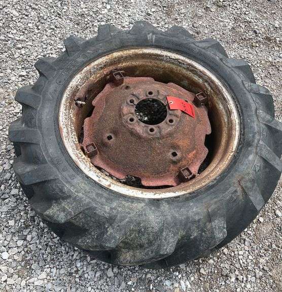 24" Rear tractor wheel with poor tire, 11.2 x 24, rim needs repair ...