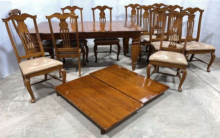 Solid oak table with two drawers, (2) Leaves, and (12) Chairs, table ...