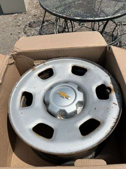 (4) 16" Chevrolet truck rims with hubcaps, used - Albrecht Auction Service