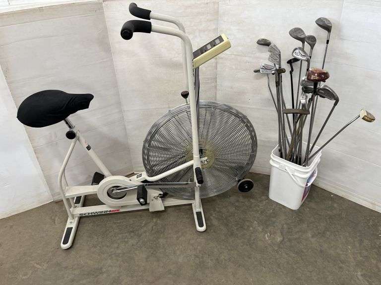 Exercise bike, and set of golf clubs, bike- 48"H - Albrecht Auction Service