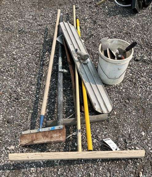 Various cement finishing tools, includes a bucket of cement hand tools ...