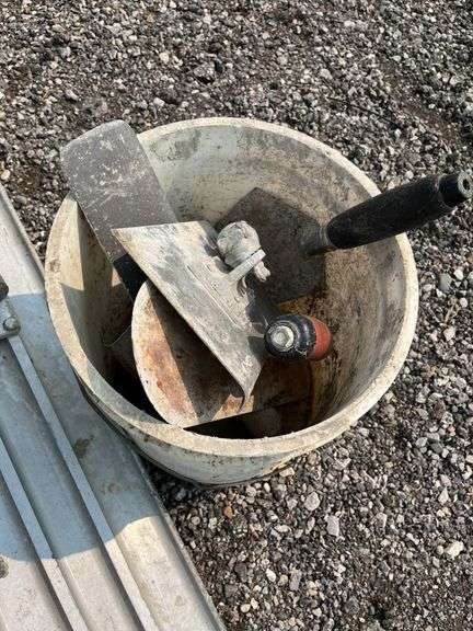 Various cement finishing tools, includes a bucket of cement hand tools ...