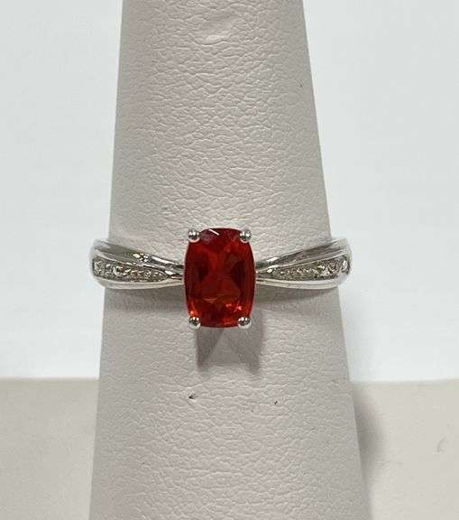 Red/orange stone with diamond accents set in a 14K white gold band ...
