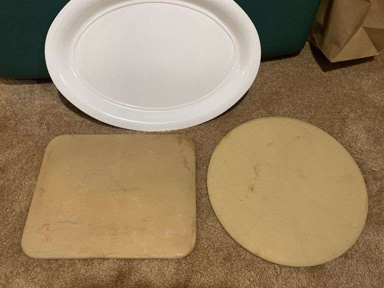 Two Pampered Chef pizza stones and white plastic platter - Auction Ohio