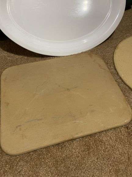 Two Pampered Chef pizza stones and white plastic platter - Auction Ohio